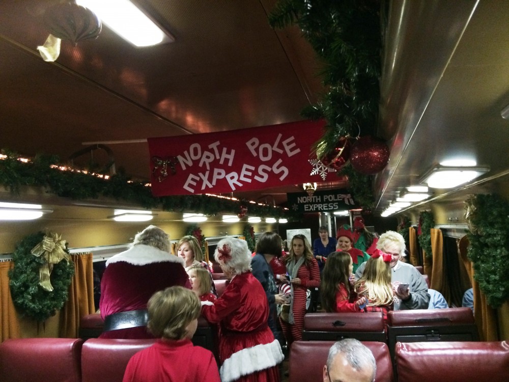 Children take a storybook train ride to meet Santa on his own turf ...